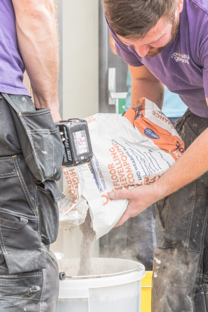 Setcrete powder being added to mixing bucket - Professional Builder